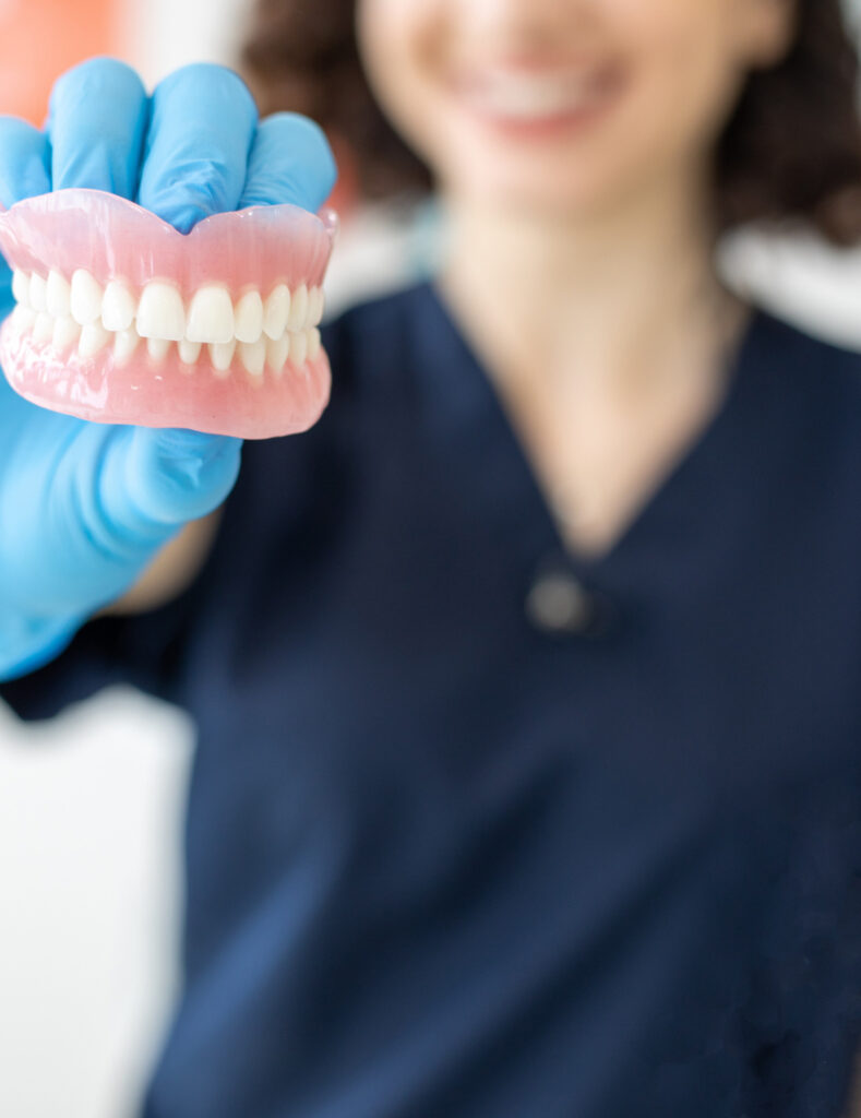 How can I adjust to dentures?